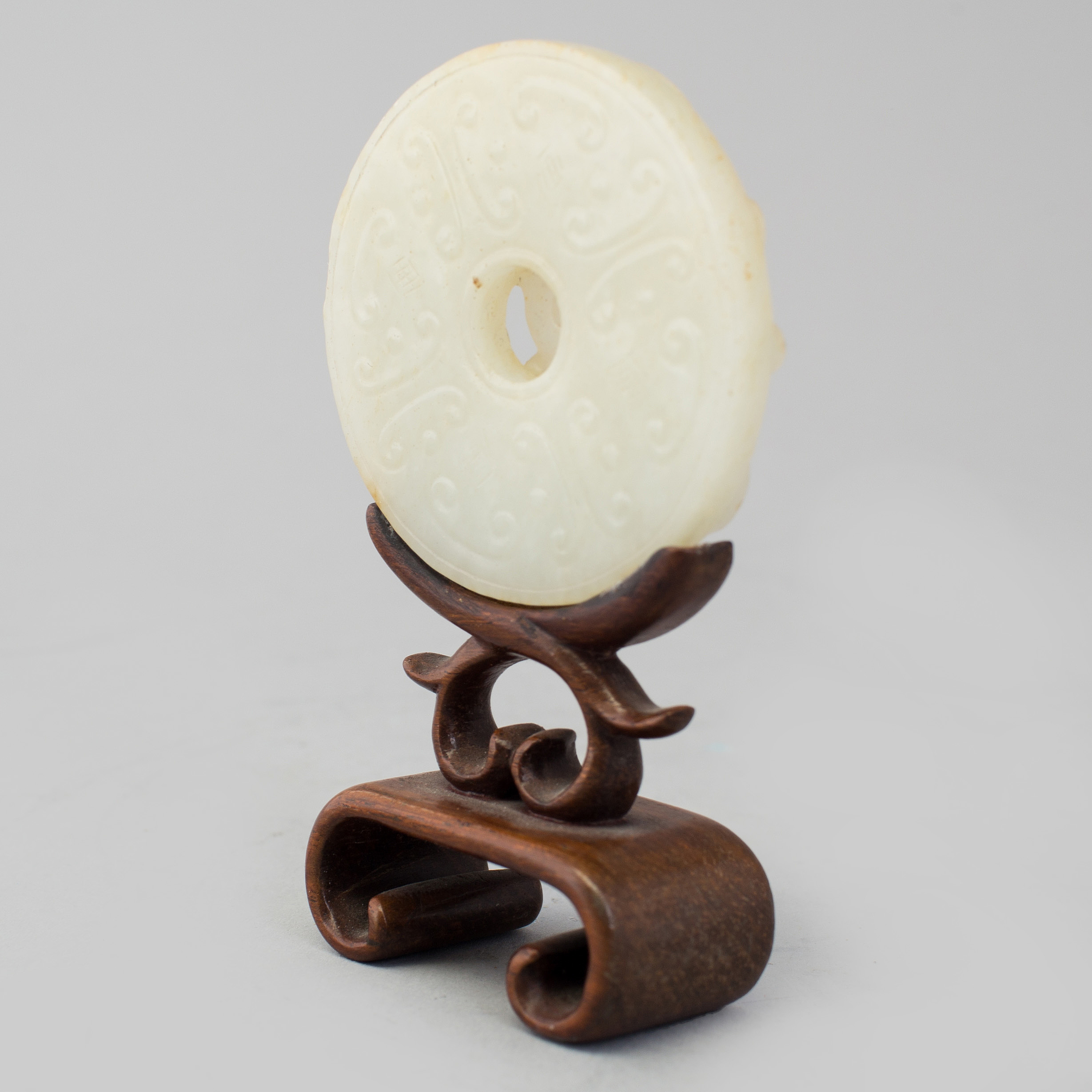 A chinese 20th century relief carved bi disc nephrite sculpture ...