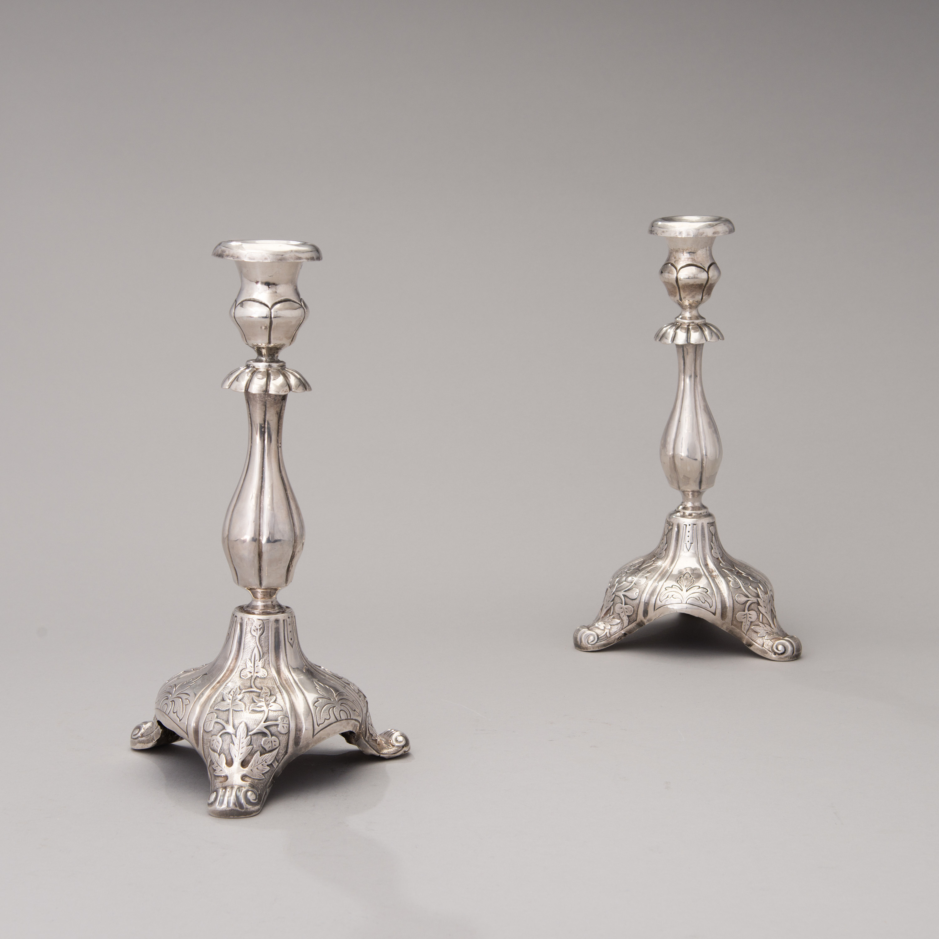 A PAIR OF RUSSIAN SILVER CANDLESTICKS, assay mark of Ivan Yefimovich ...
