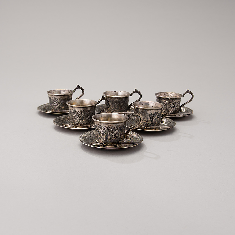 A set of six Persian silver coffee cups with spoons and saucers and six ...