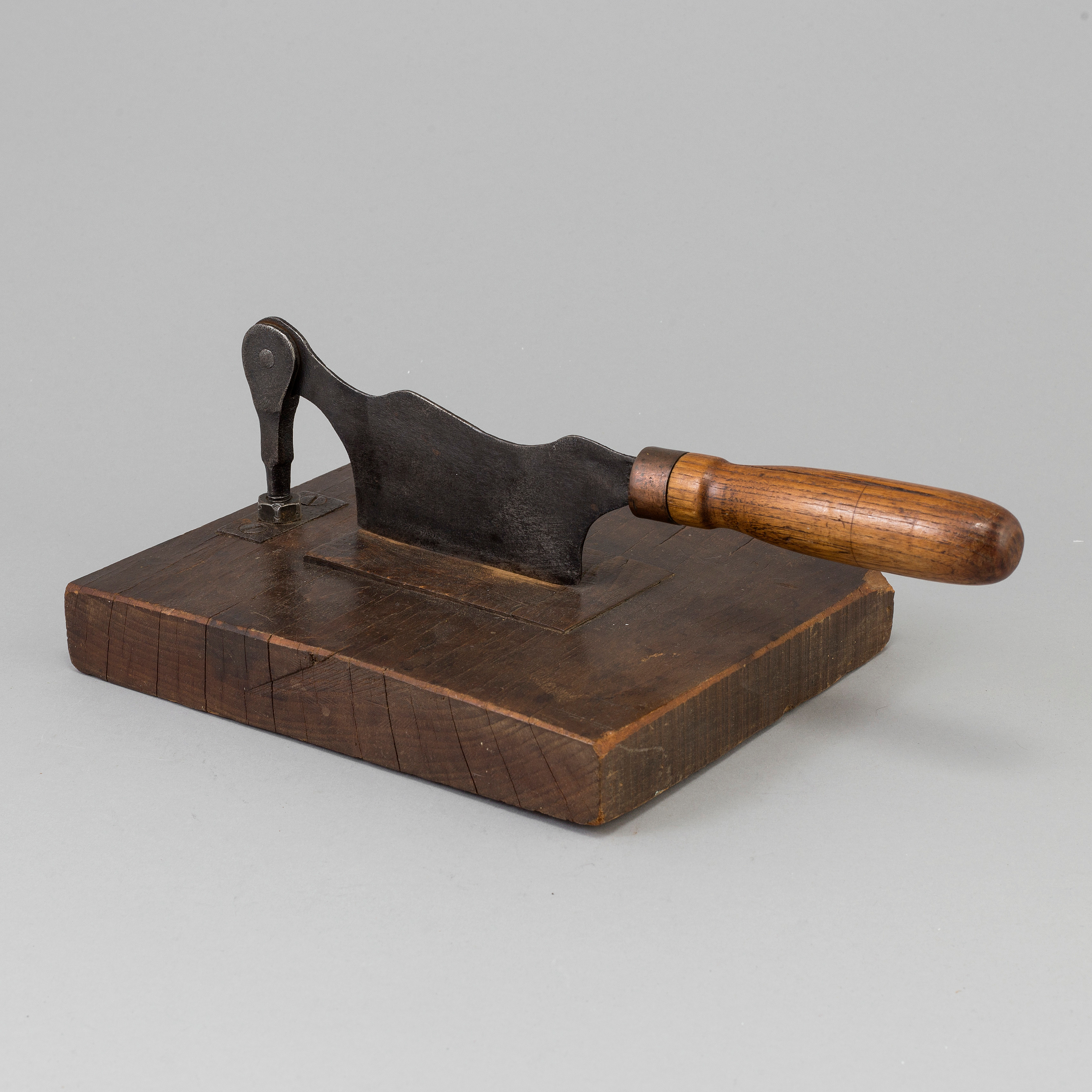 A 19TH CENTURY TOBACCO CUTTER, wood and iron. - Bukowskis