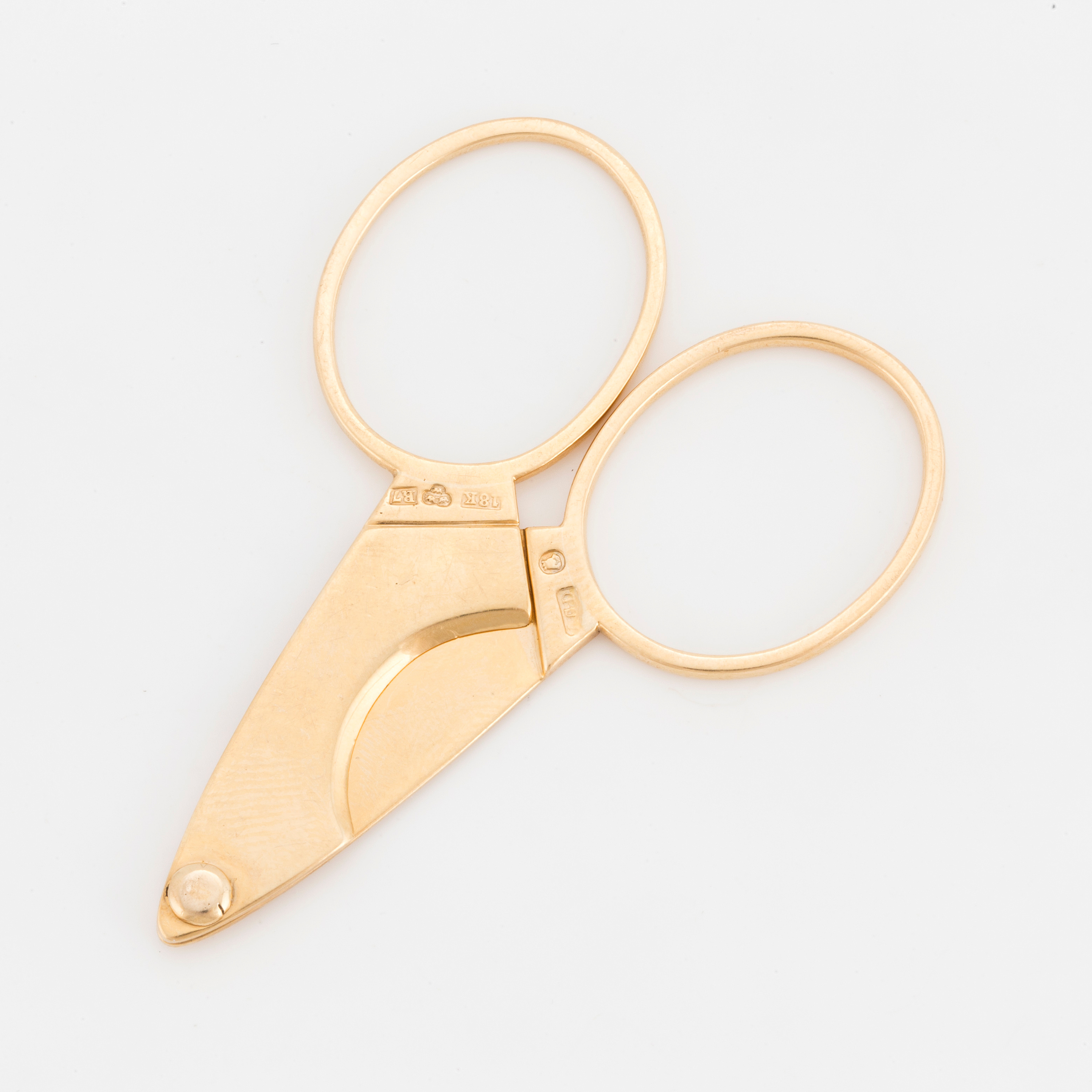 An 18K gold cigar-cutter. - Bukowskis