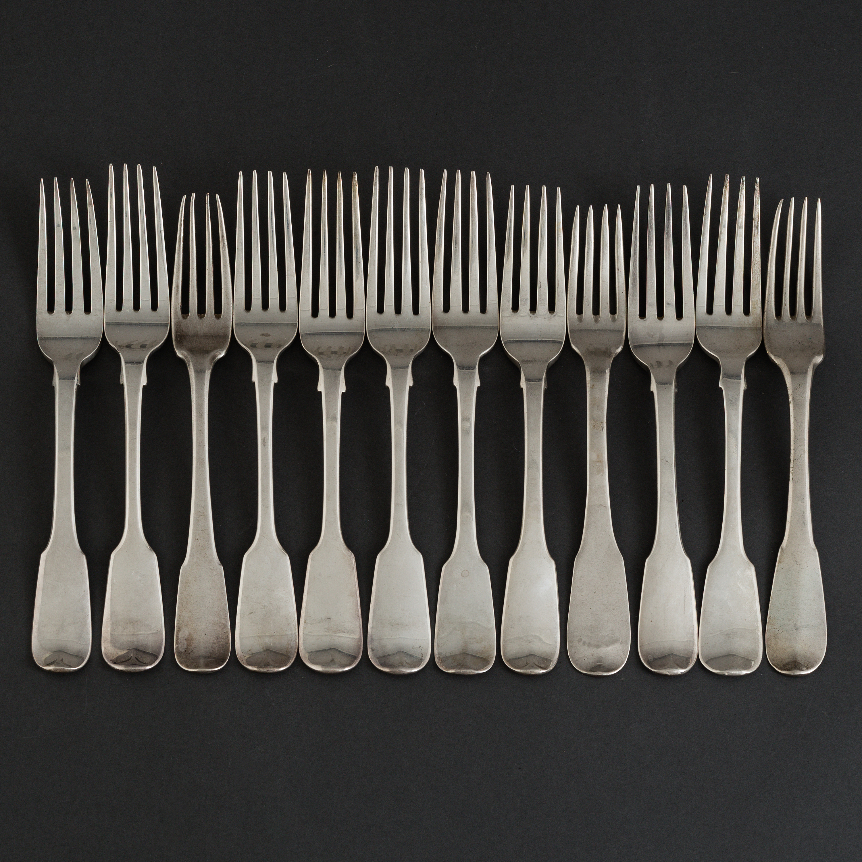 12 English silver forks mainly from the 19th century, some with ...