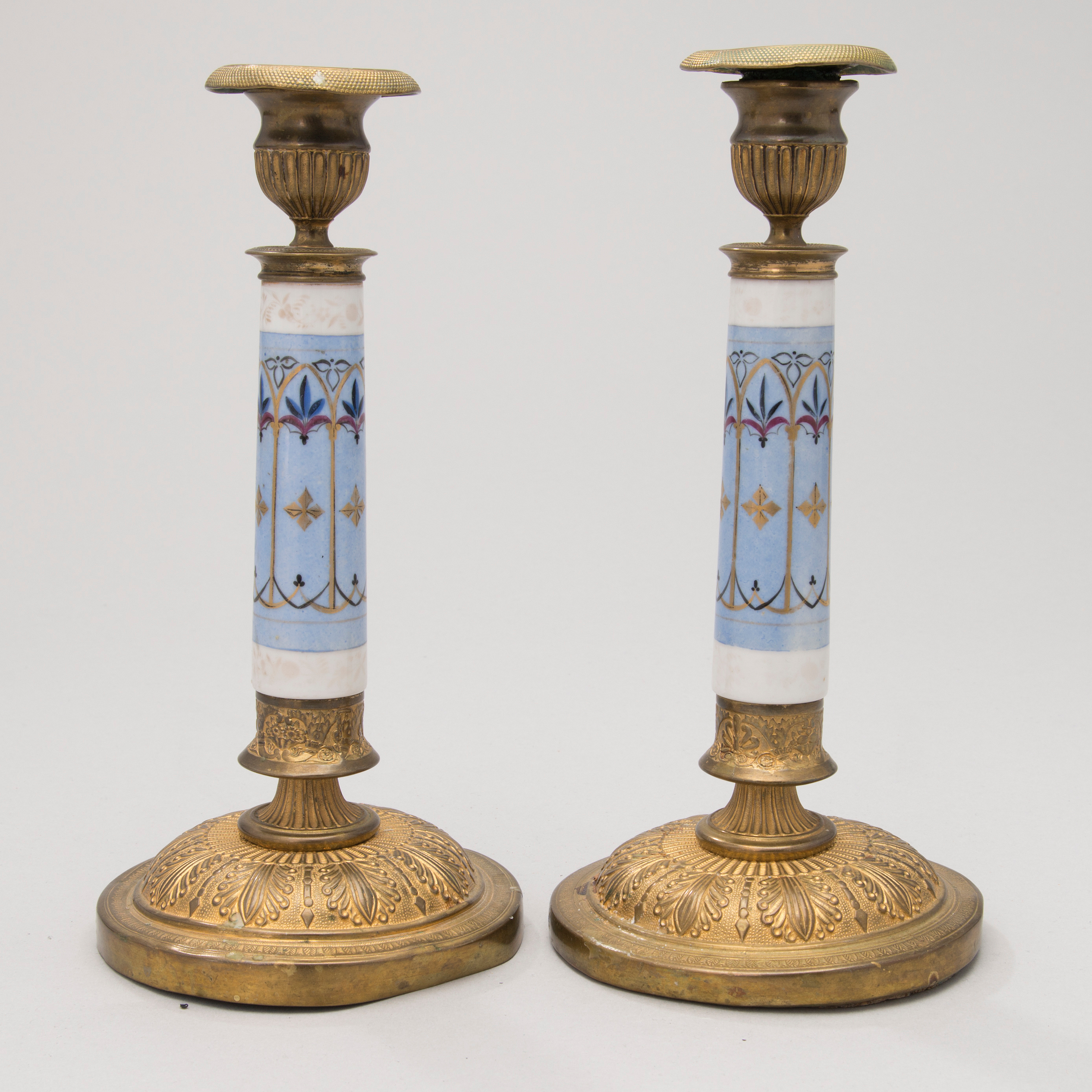 A PAIR OF RUSSIAN CANDLESTICKS, bronze and porcelain, first half of the ...