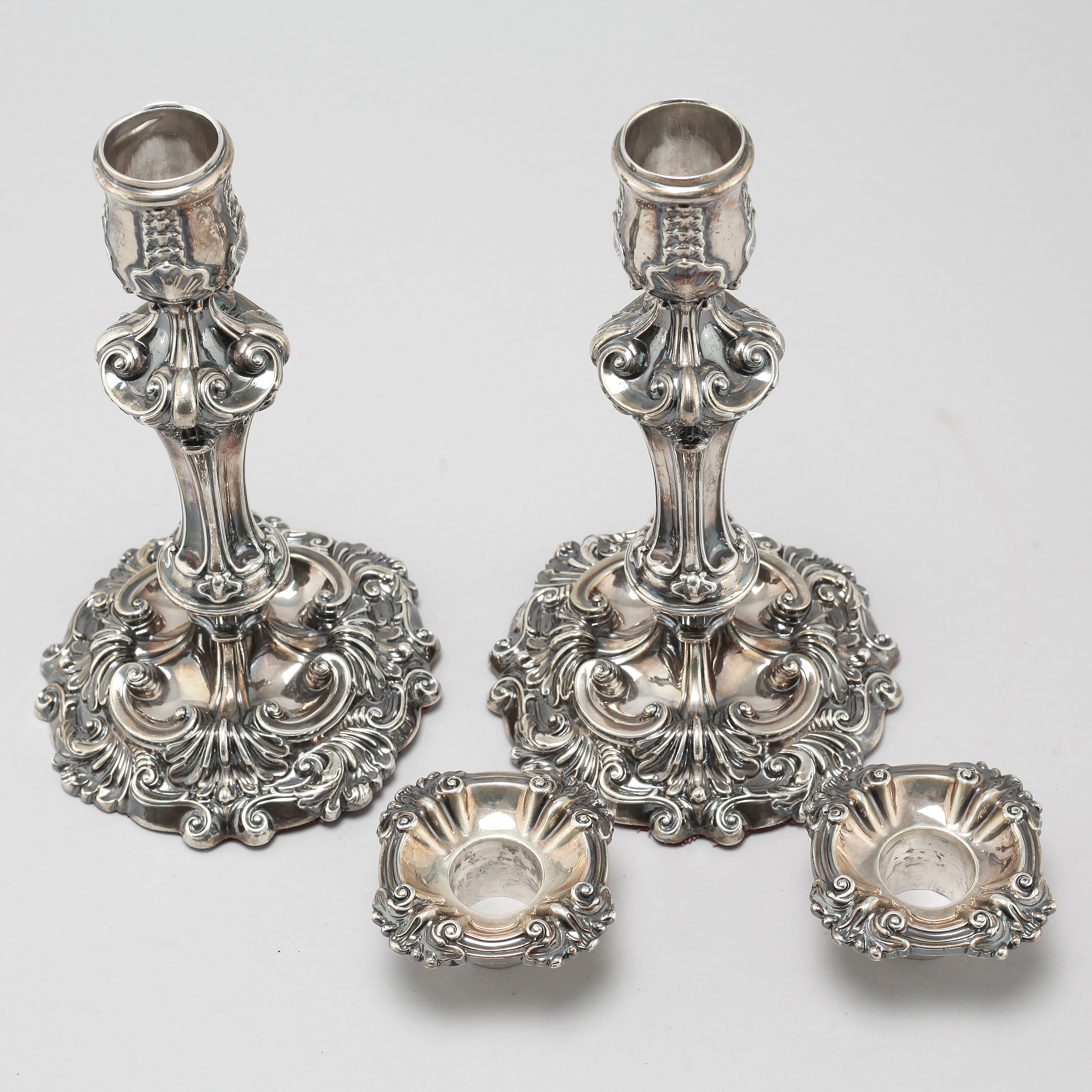 A pair of silver rococo style candlesticks from England, 19th century ...