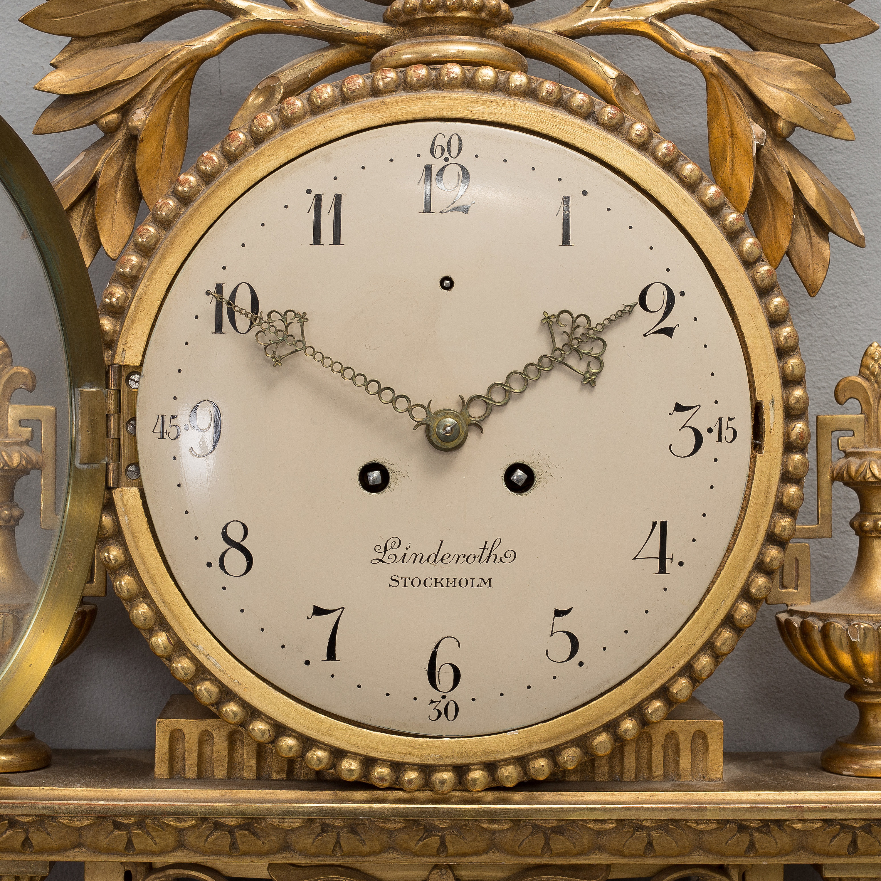 A Swedish Gustavian style gilt wood wall clock, marked Linderoth ...