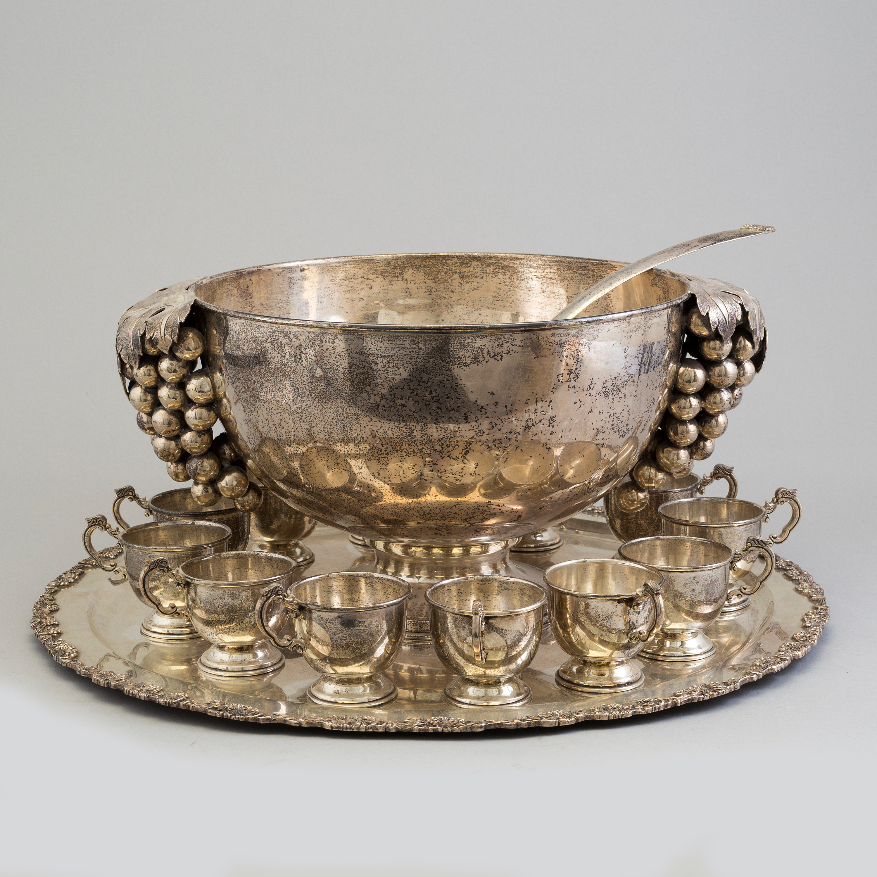 A first half of the 20th century silver punch bowl with twelve cups ...